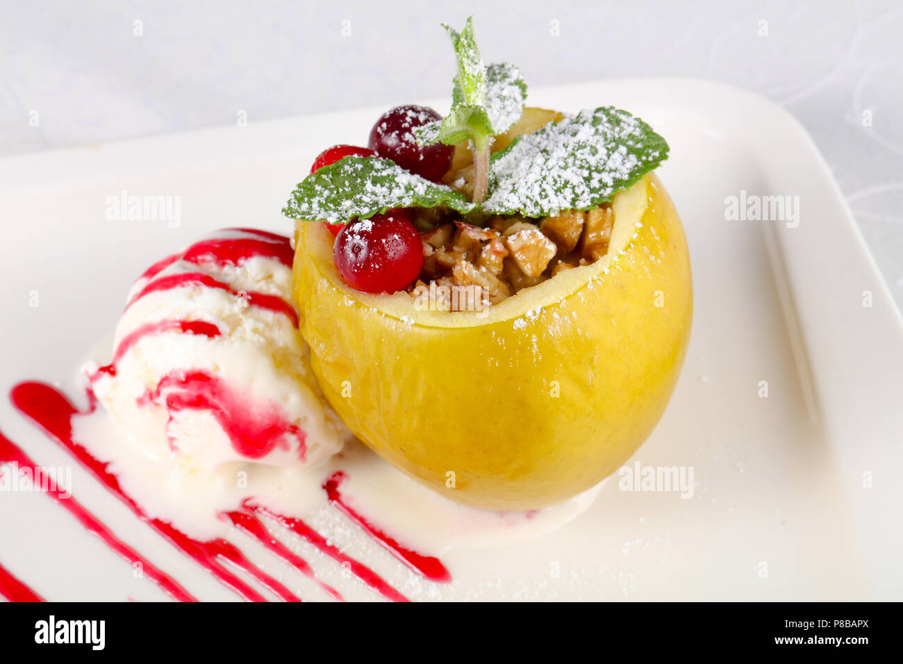 Apple stuffed nuts with ice-cream Stock Photo - Alamy