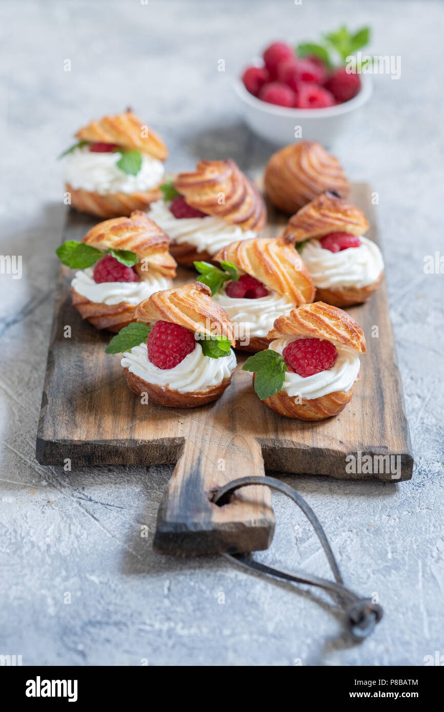Raspberries Profiteroles with White Chocolate cream Stock Photo - Alamy