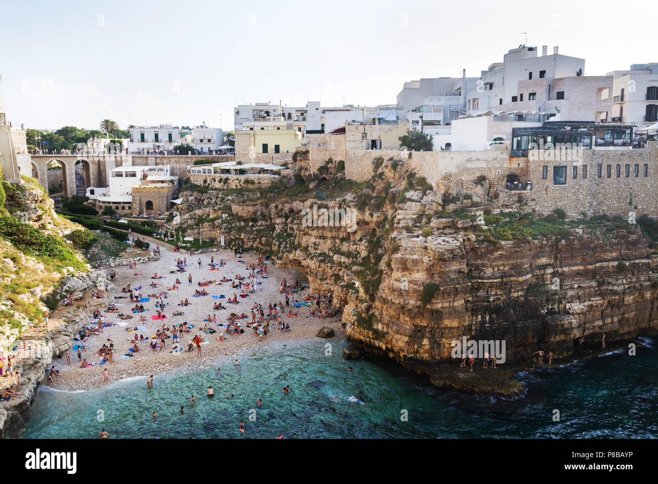People on beach Lama Monachile in Polignano a Mare, Italy Stock Photo ...