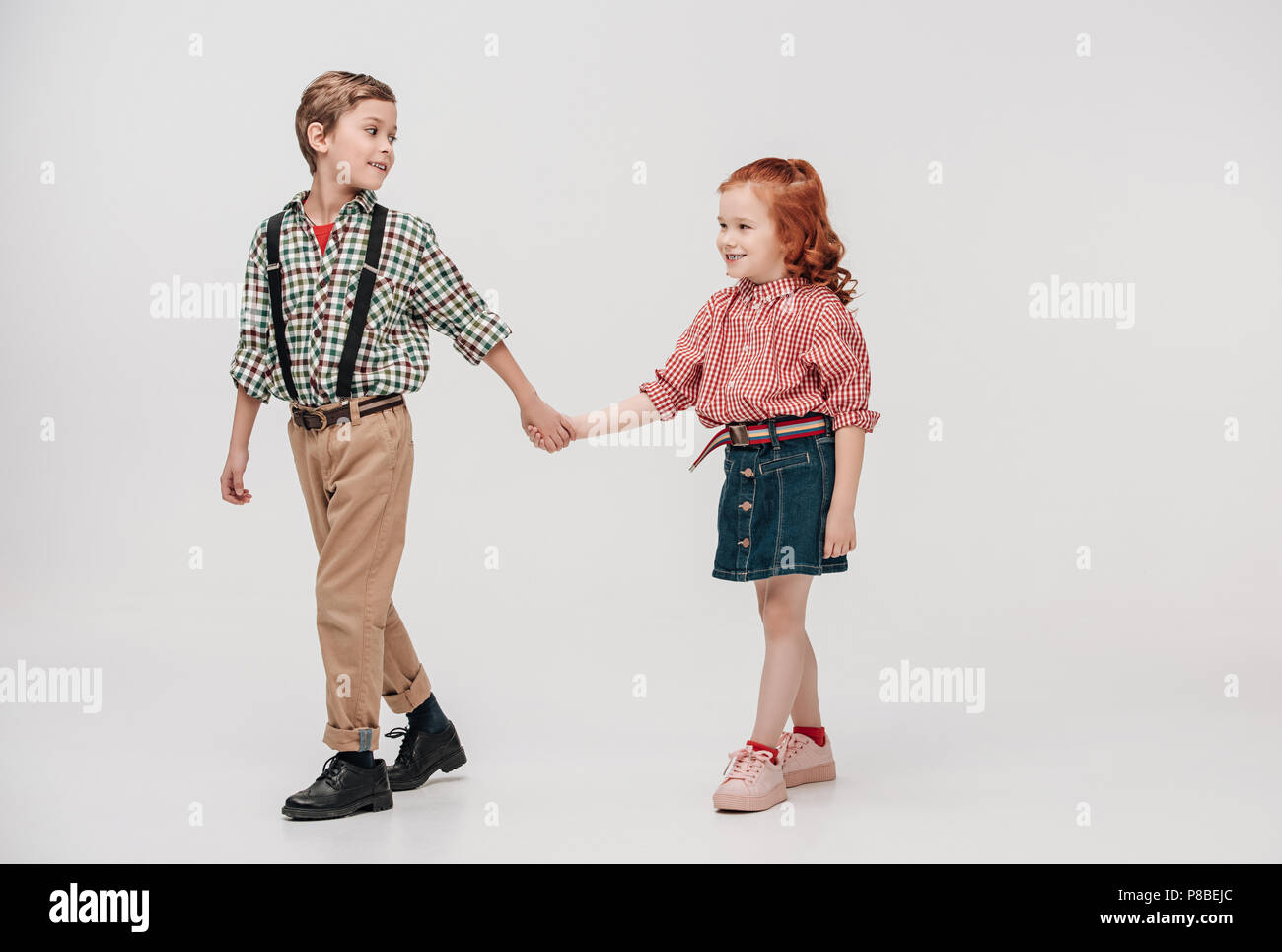 adorable little kids holding hands and walking together isolated on ...
