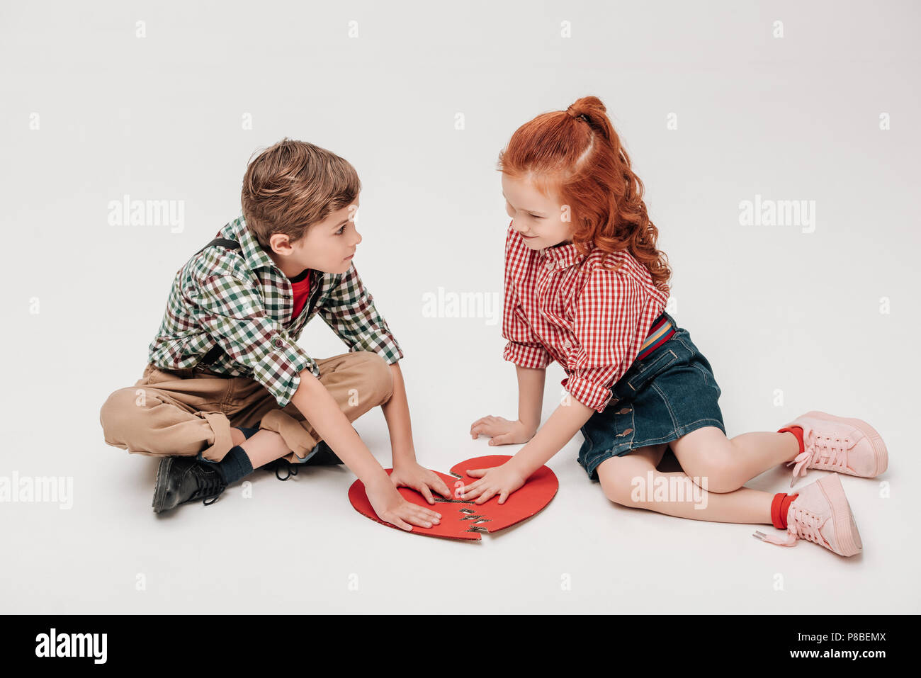 adorable little kids putting parts of broken heart symbol together ...