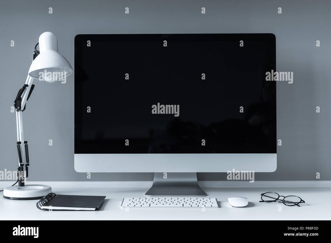 working place with computer and switched off table lamp Stock Photo - Alamy