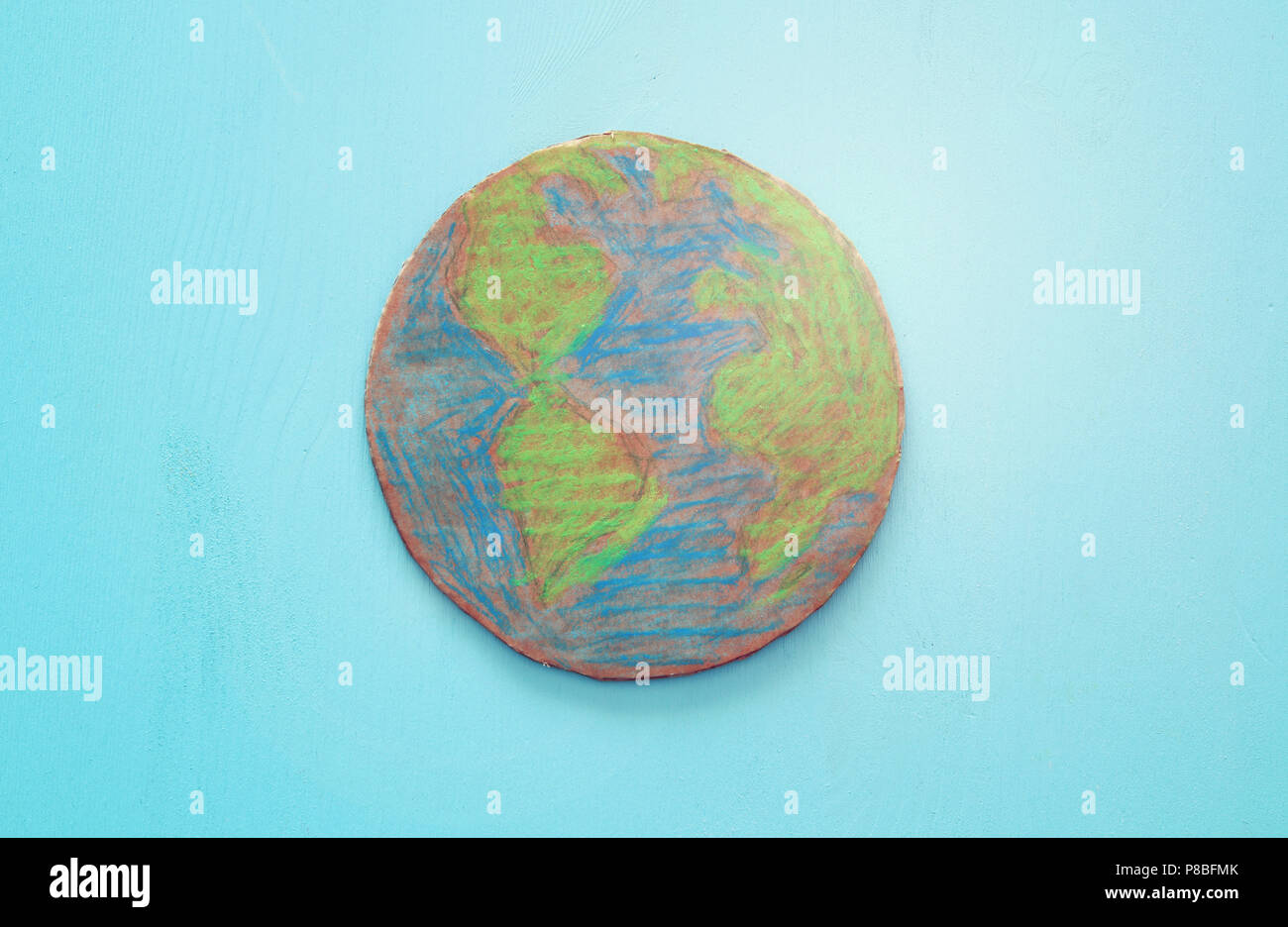 top view image of cardboard earth globe over blue wooden background ...