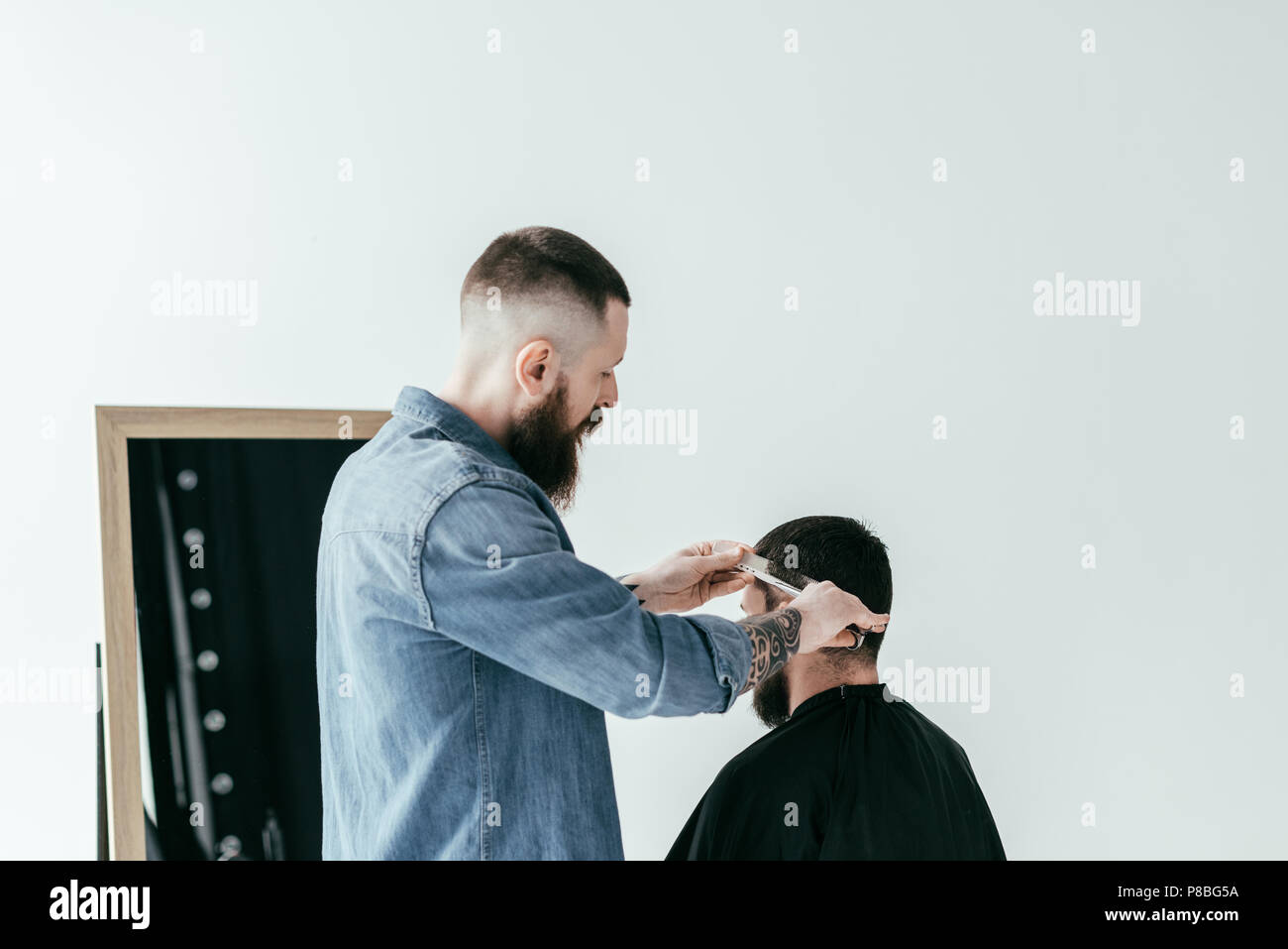 barber cutting customer hair at barbershop isolated on white Stock ...