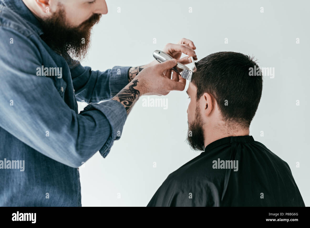 cropped image of barber shaving hair at barbershop isolated on white ...