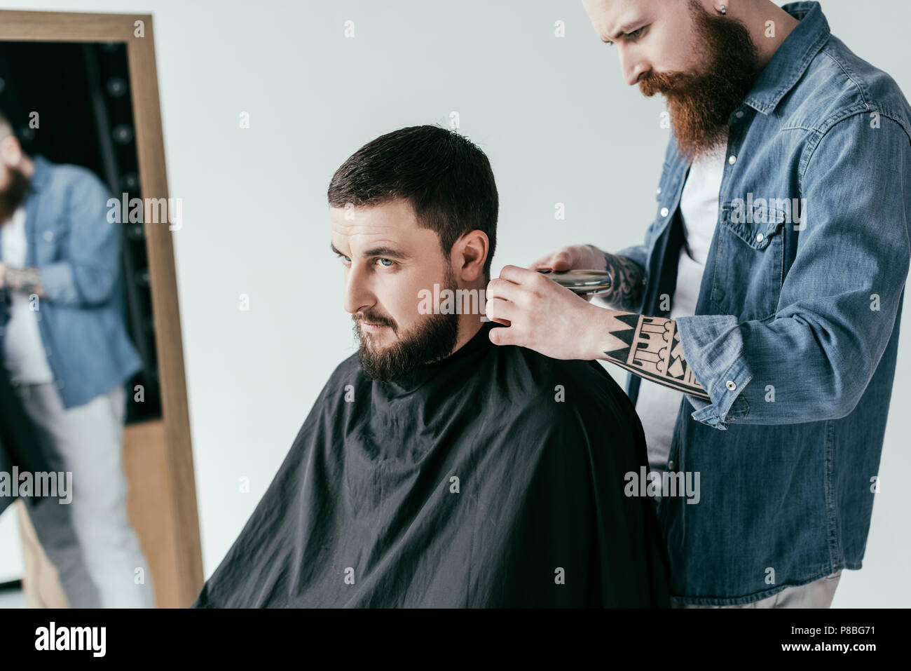 Barber styling client hair on hi-res stock photography and images - Alamy
