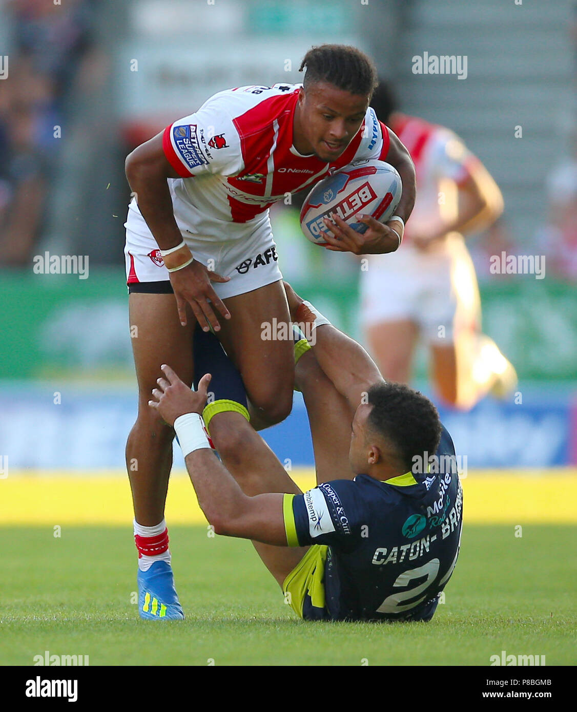 St Helen's Regan Grace (left) and Wakefield Trinity's Mason Caton-Brown ...