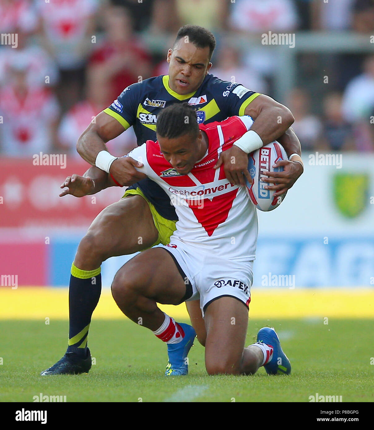 St Helen's Regan Grace (left) and Wakefield Trinity's Mason Caton-Brown ...