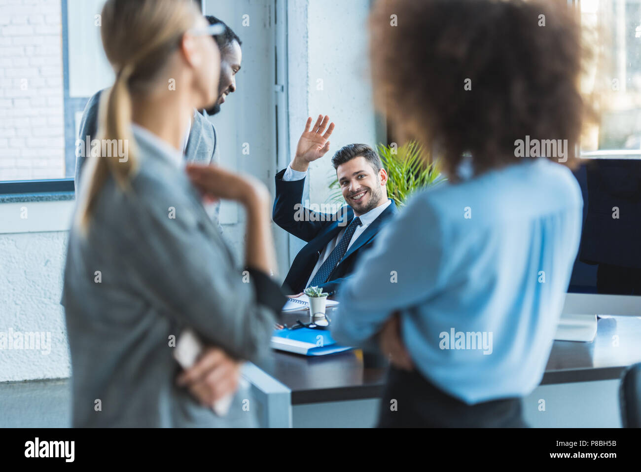 Waving hand to colleagues hi-res stock photography and images - Alamy