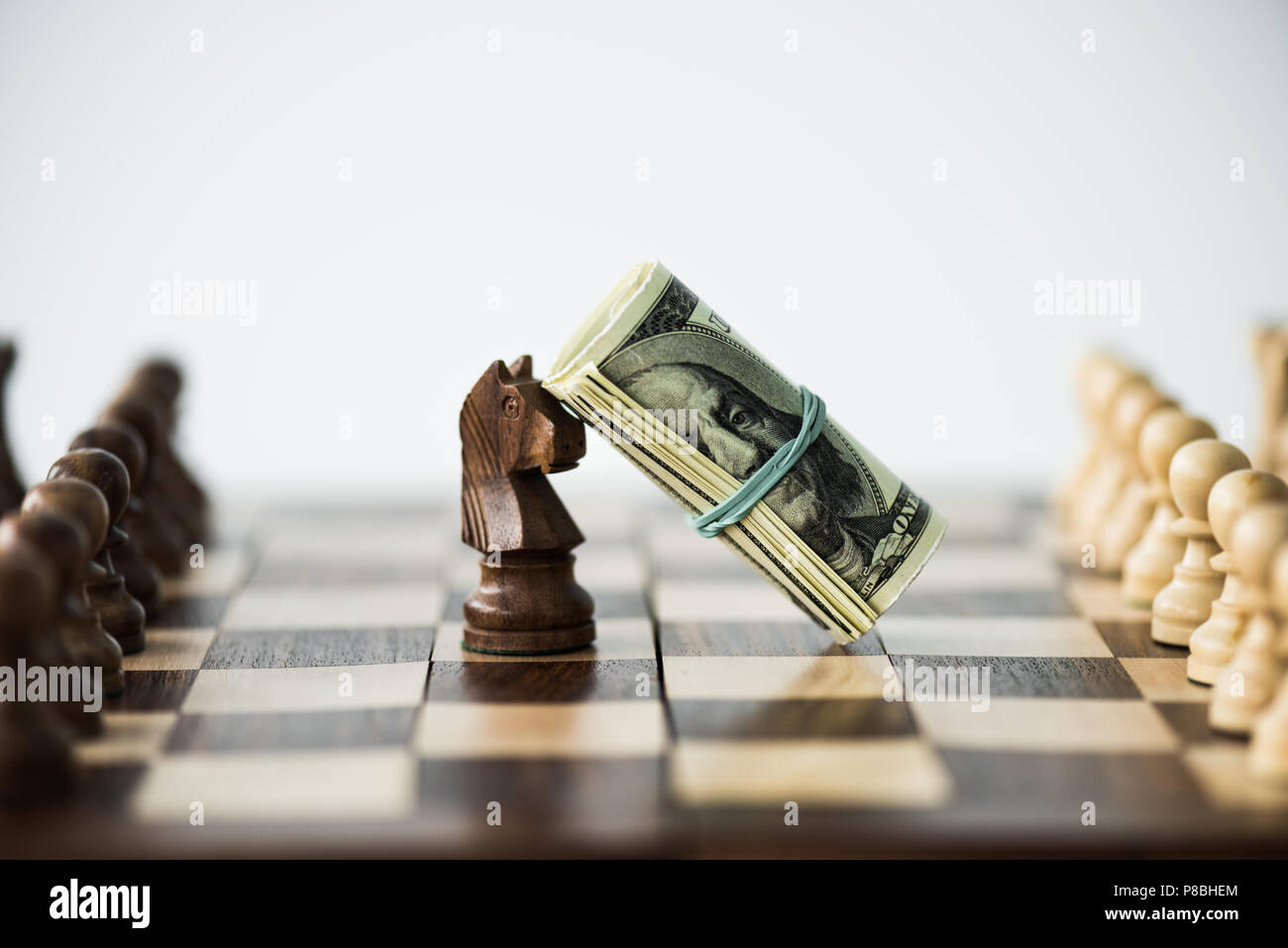 Close up view of chess board with cash and black knight isolated on ...