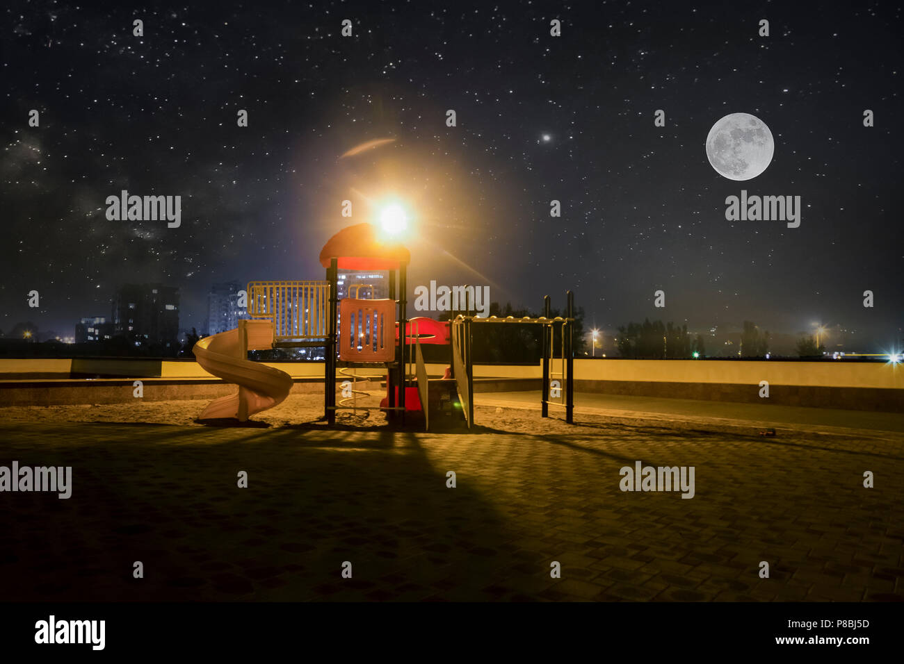 an empty playground against the background of the starry sky and the ...