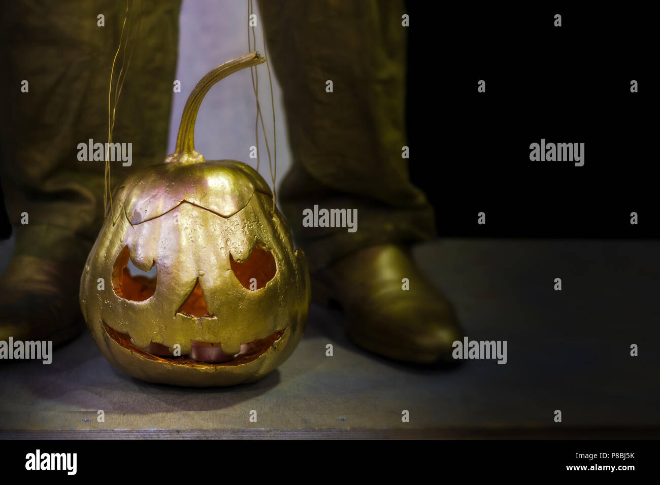 golden pumpkin with ropes standing on the floor, background image with ...