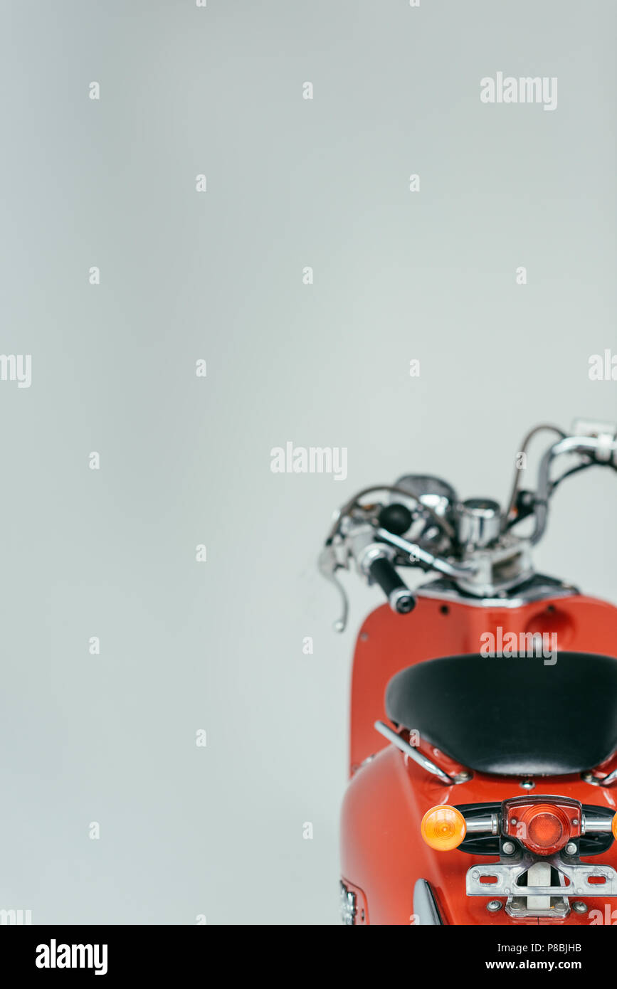 Red retro scooter isolated on grey Stock Photo - Alamy