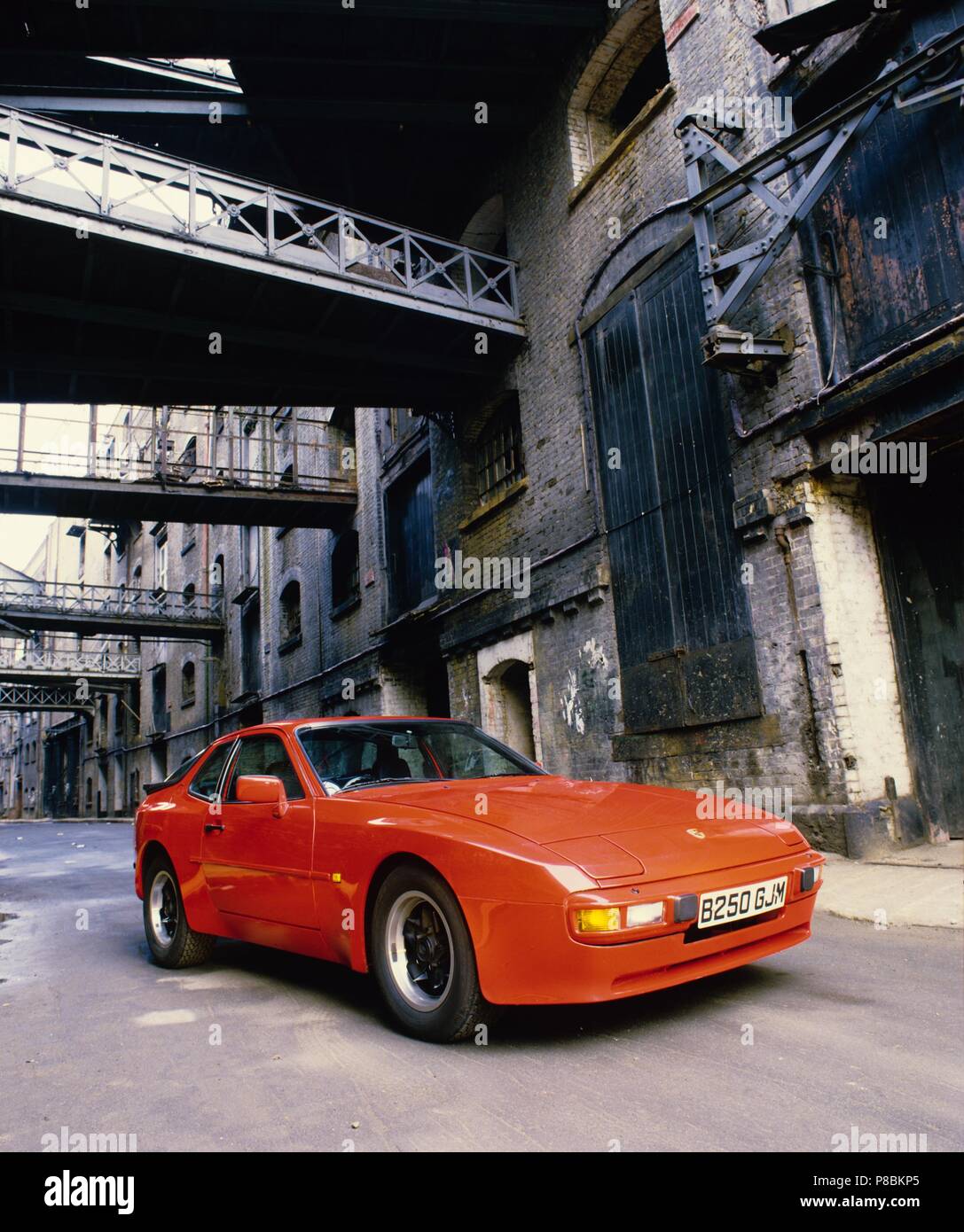 Porsche 944 - 1985 model year shown in guards red paint in an urban ...