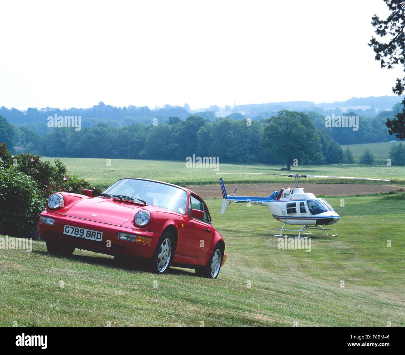 Porsche 911 Carrera 4 - 1990 model year in guards red in a mansion and ...