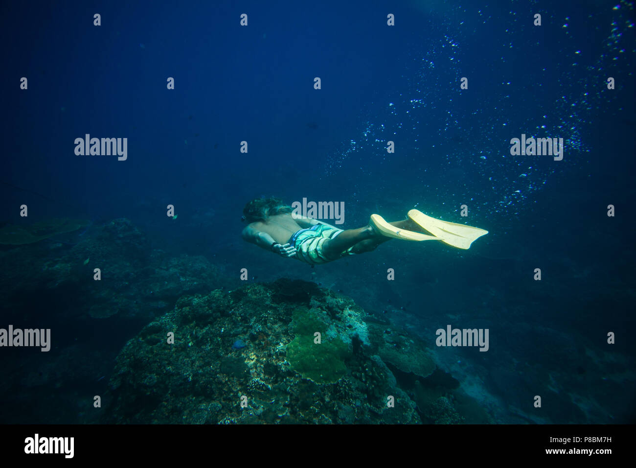 side view of man in flippers diving in ocean alone Stock Photo - Alamy