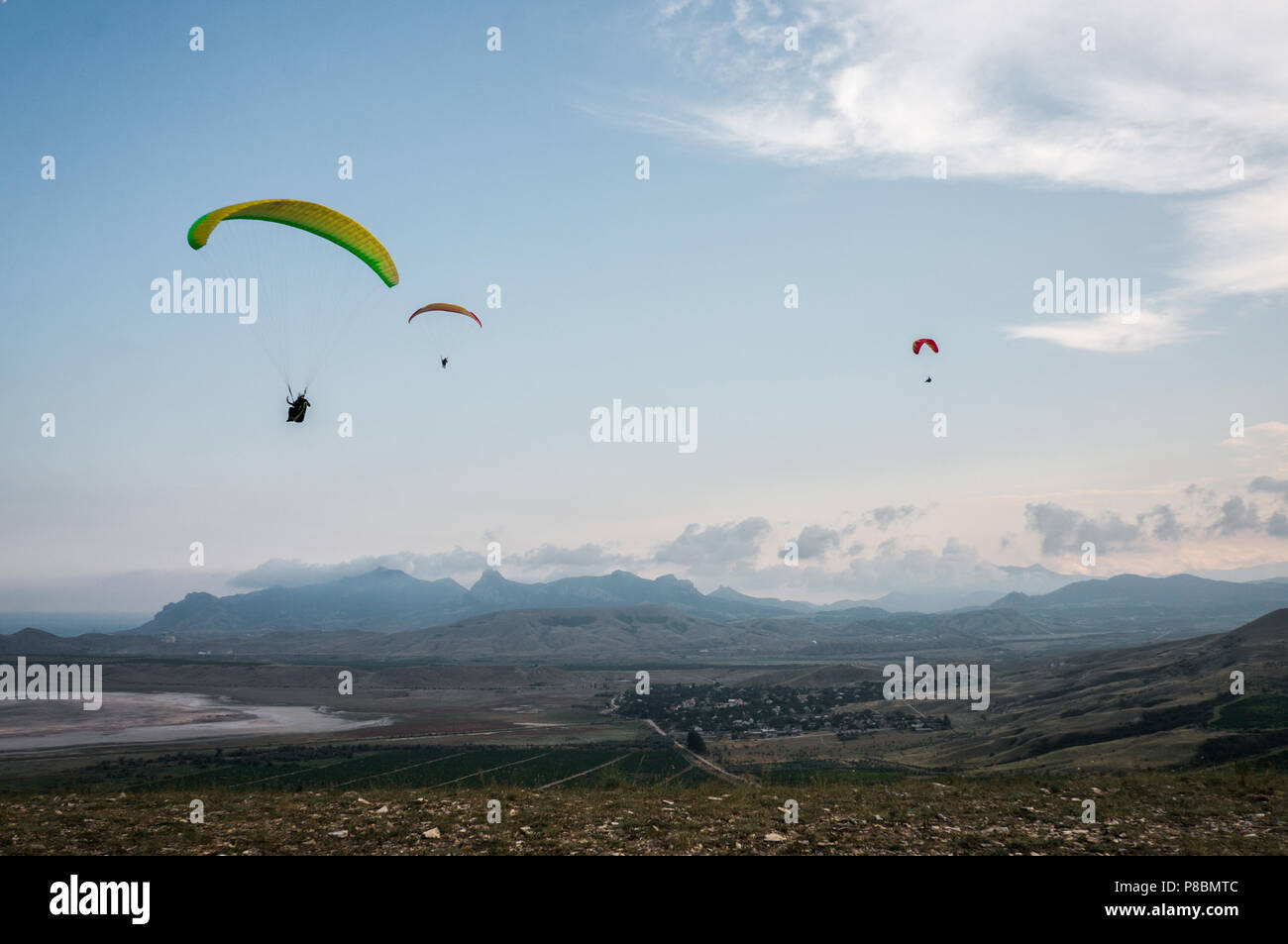 people flying on paraplanes sky with clouds on background Stock Photo ...