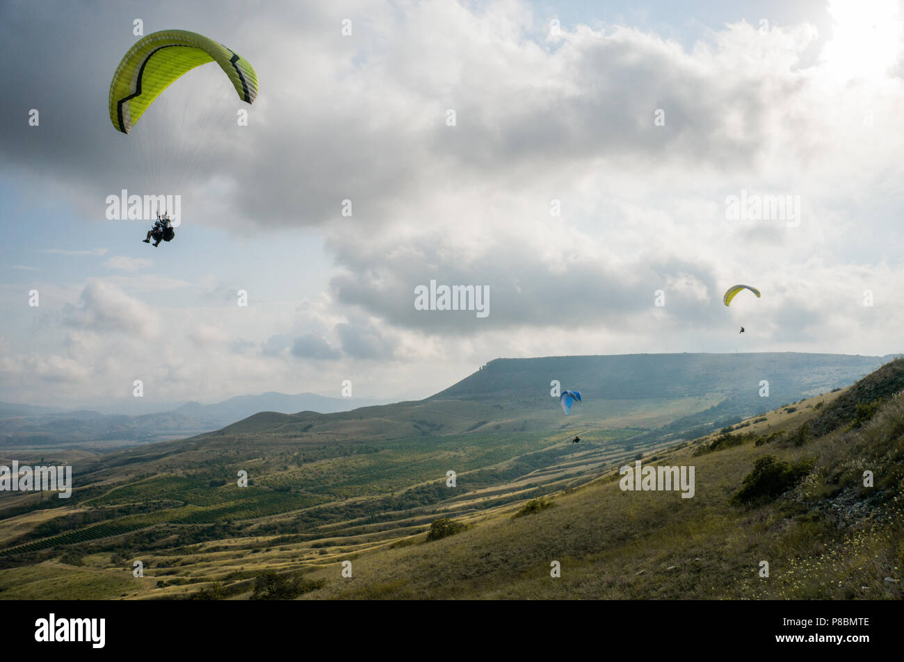 people flying on paraplanes sky with clouds on background Stock Photo ...