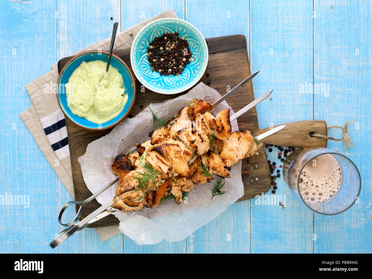 Shish kebab with beer and sauce on a wooden board top view Stock Photo ...