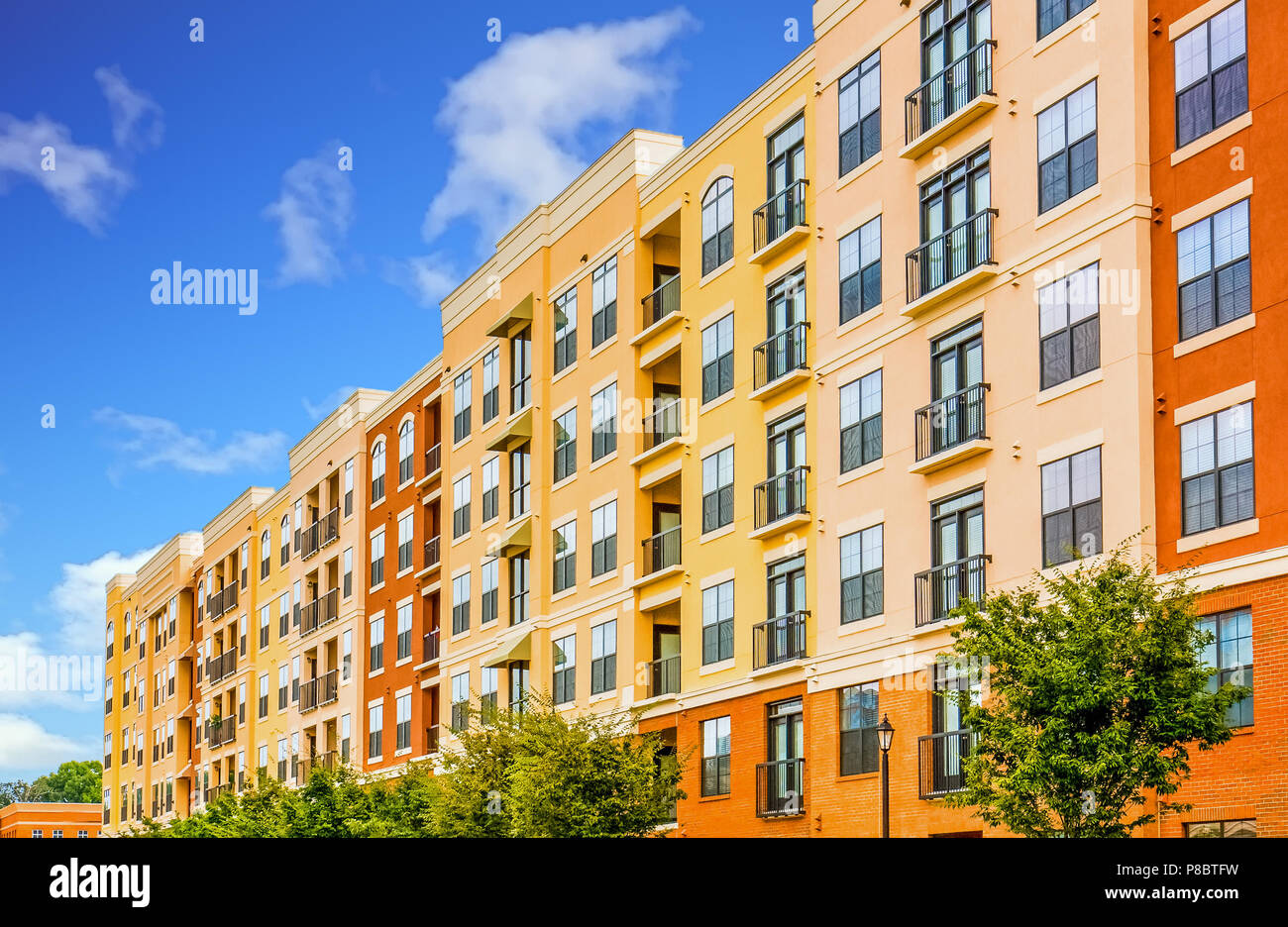 A modern condo building of yellow and brown Stock Photo - Alamy