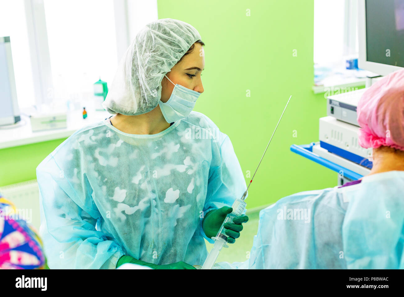 cosmetic liposuction surgery in actual operating room setting showing ...