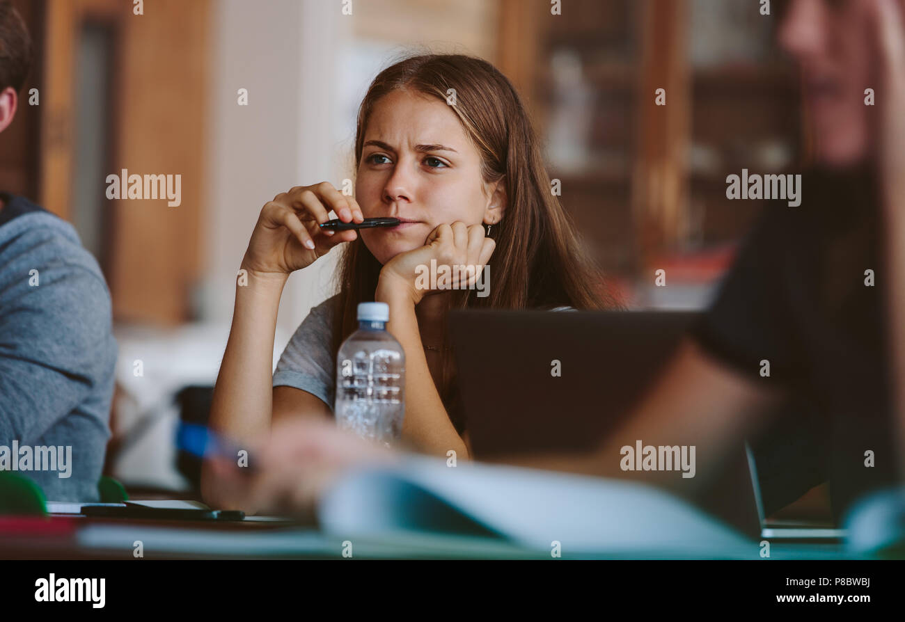Female student listening to lecture in college classroom. Woman ...