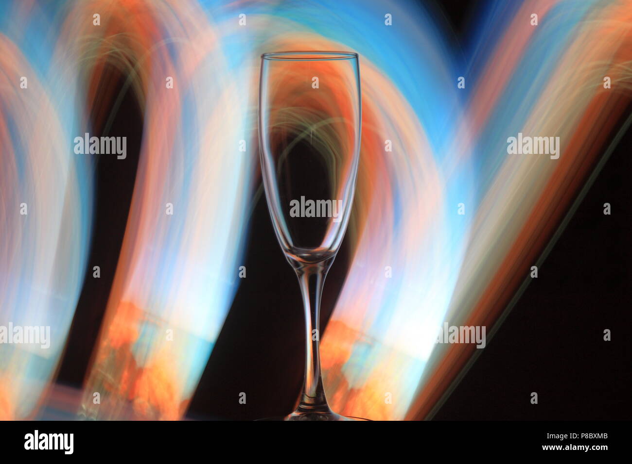 Night photo of champagne glass with bright lights and sparks on the ...