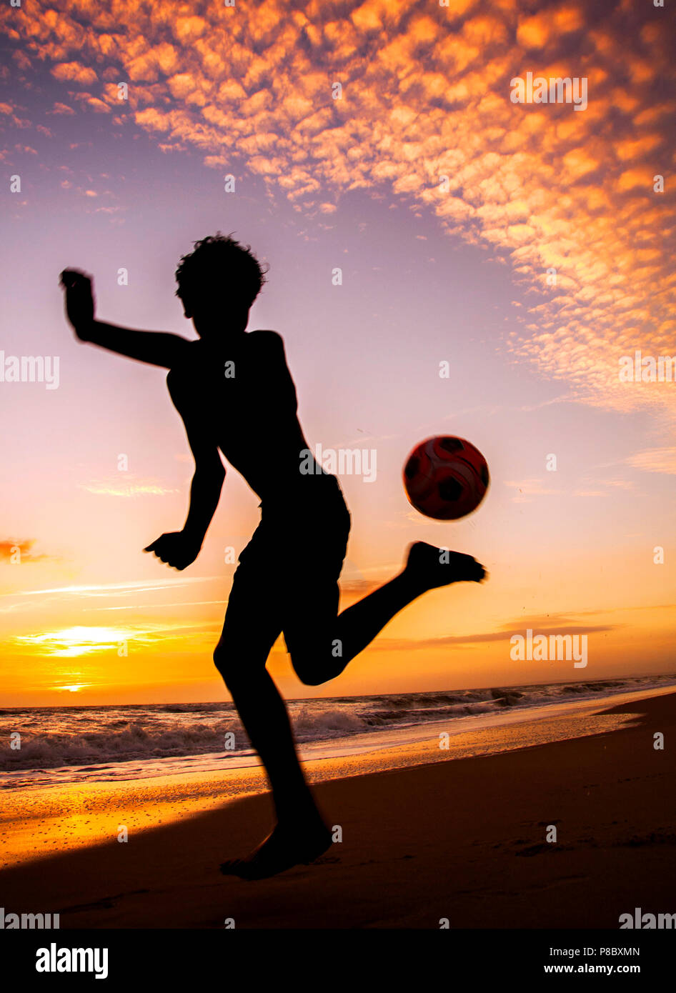 Boy soccer ball sunset sea hi-res stock photography and images - Alamy