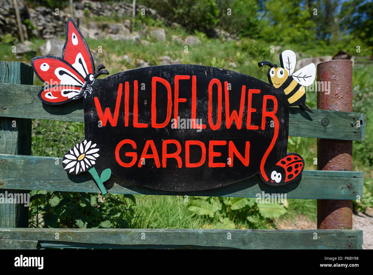 A handmade sign for a wildflower nature garden designed to attract ...