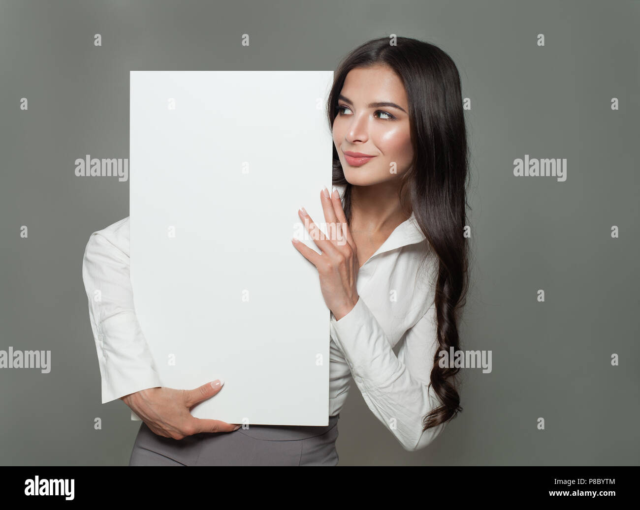 Young businesswoman holding white blank paper banner background with ...