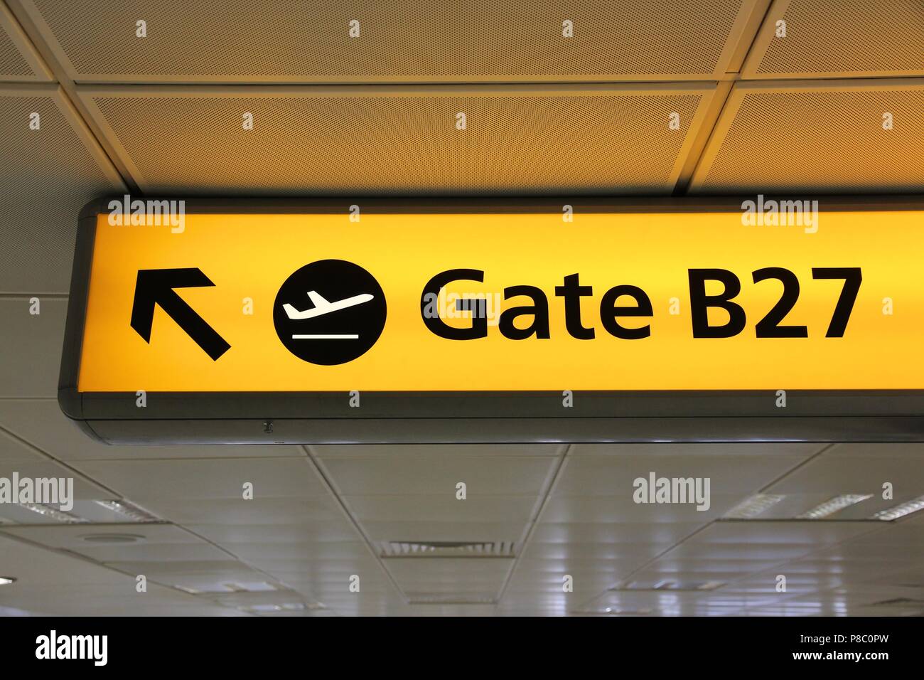 Generic airport signage in London Heathrow. Illuminated gates sign ...