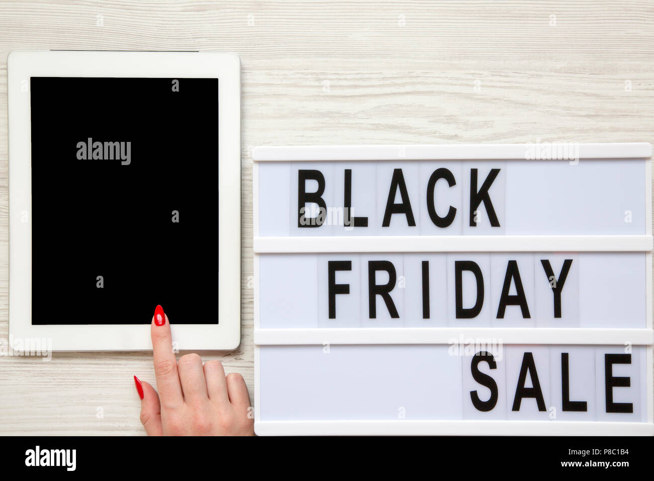 Female hand using tablet, 'Black friday sale' word on lightbox over ...