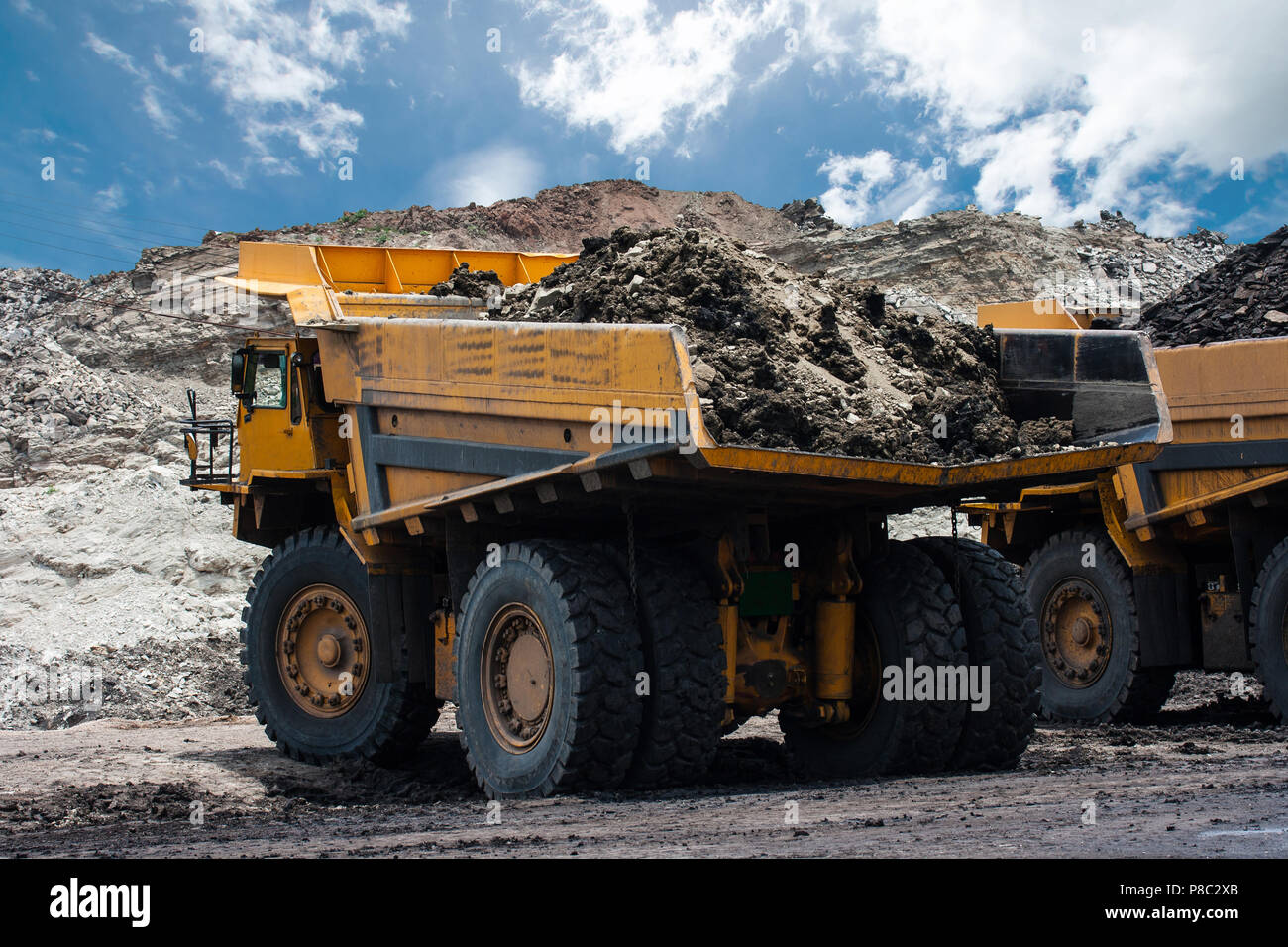 big yellow mining truck at work site Stock Photo - Alamy