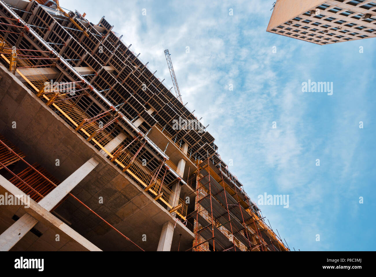Building construction site with scaffolding, low angle view Stock Photo ...