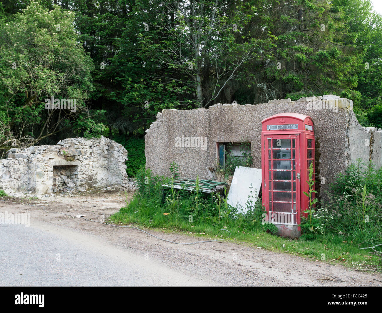 A faded red telephone box stands next to a ruined cottage at Bridgend ...