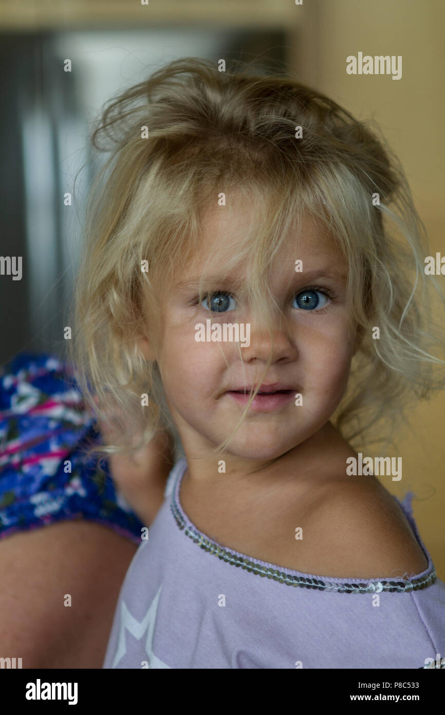 Pretty, blonde, preteen girl, profile, looking rat camera, close up ...