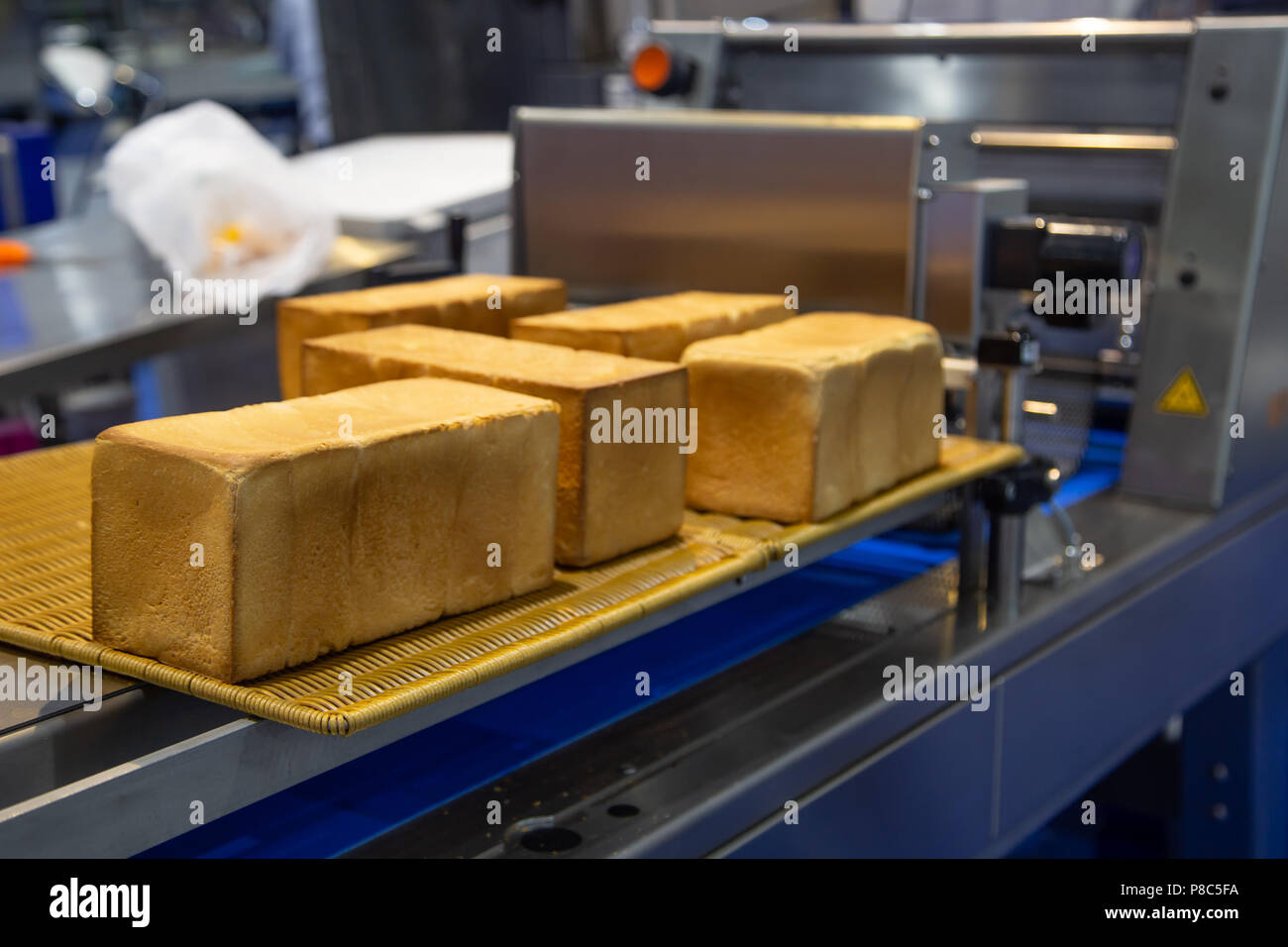 Bread slicer machine in food and bekery production line Stock Photo - Alamy