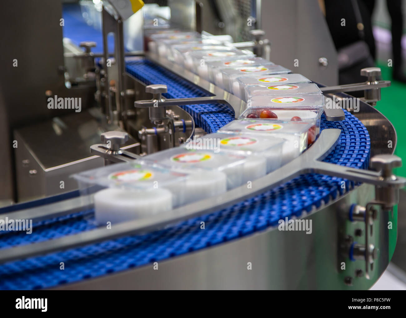 Packing food in plastic box in production line Stock Photo - Alamy
