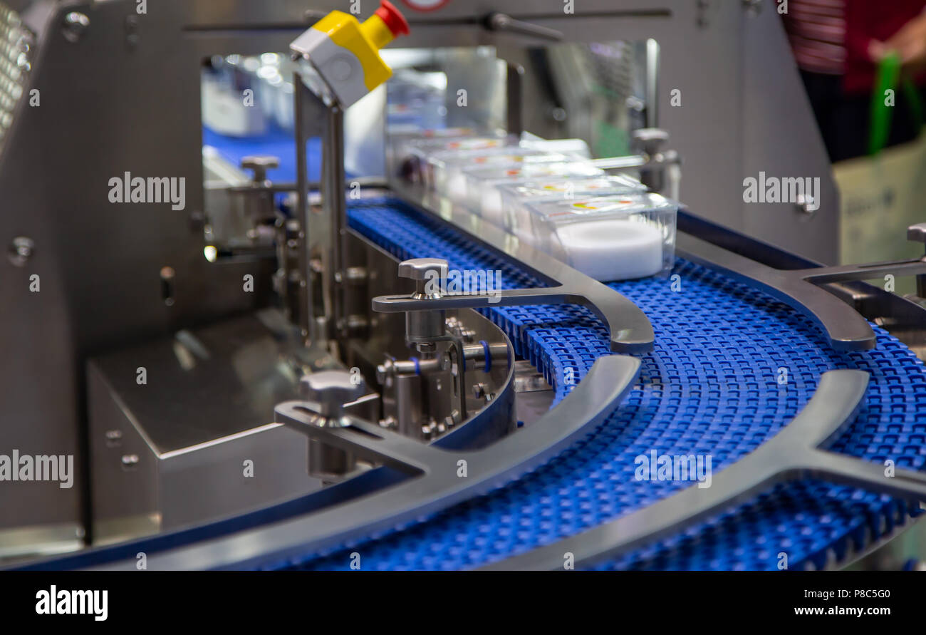 Packing food in plastic box in production line Stock Photo - Alamy