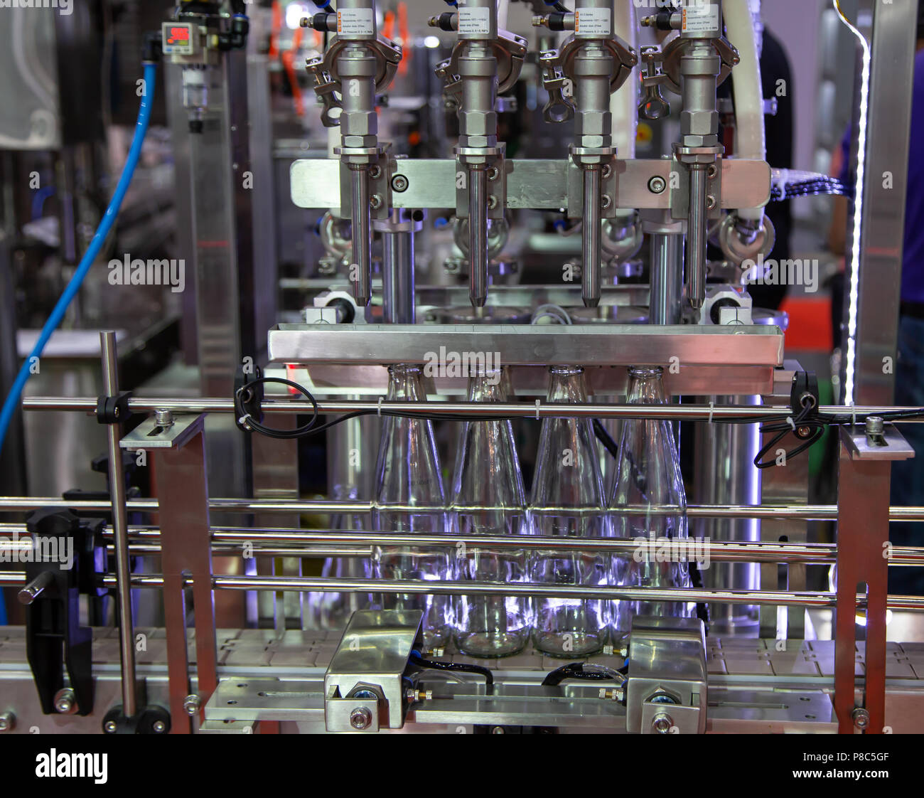 Production line of Liquid filling bottle machine Stock Photo - Alamy