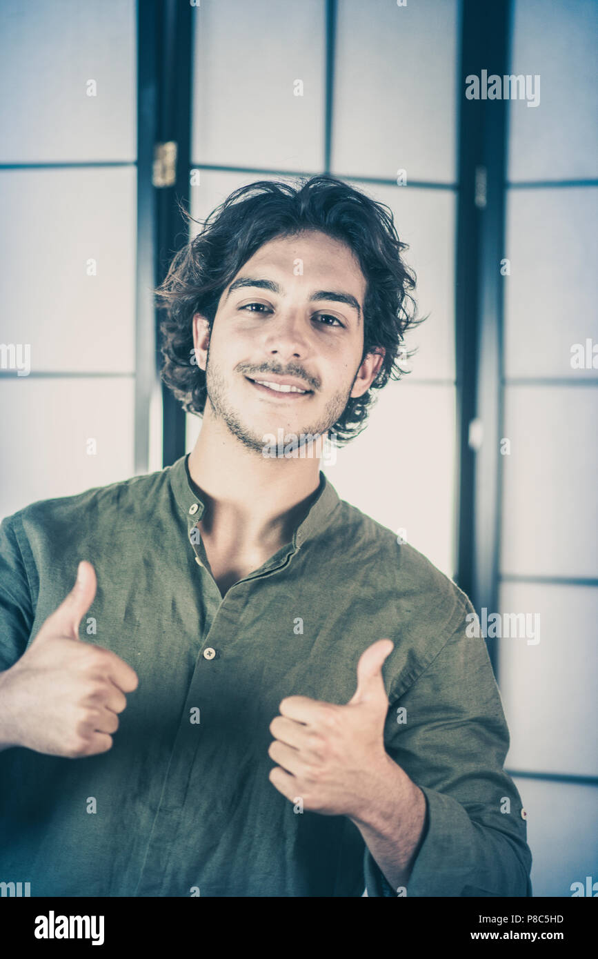 Portrait of Young Man With Raised Hands at Chest Stock Photo - Alamy