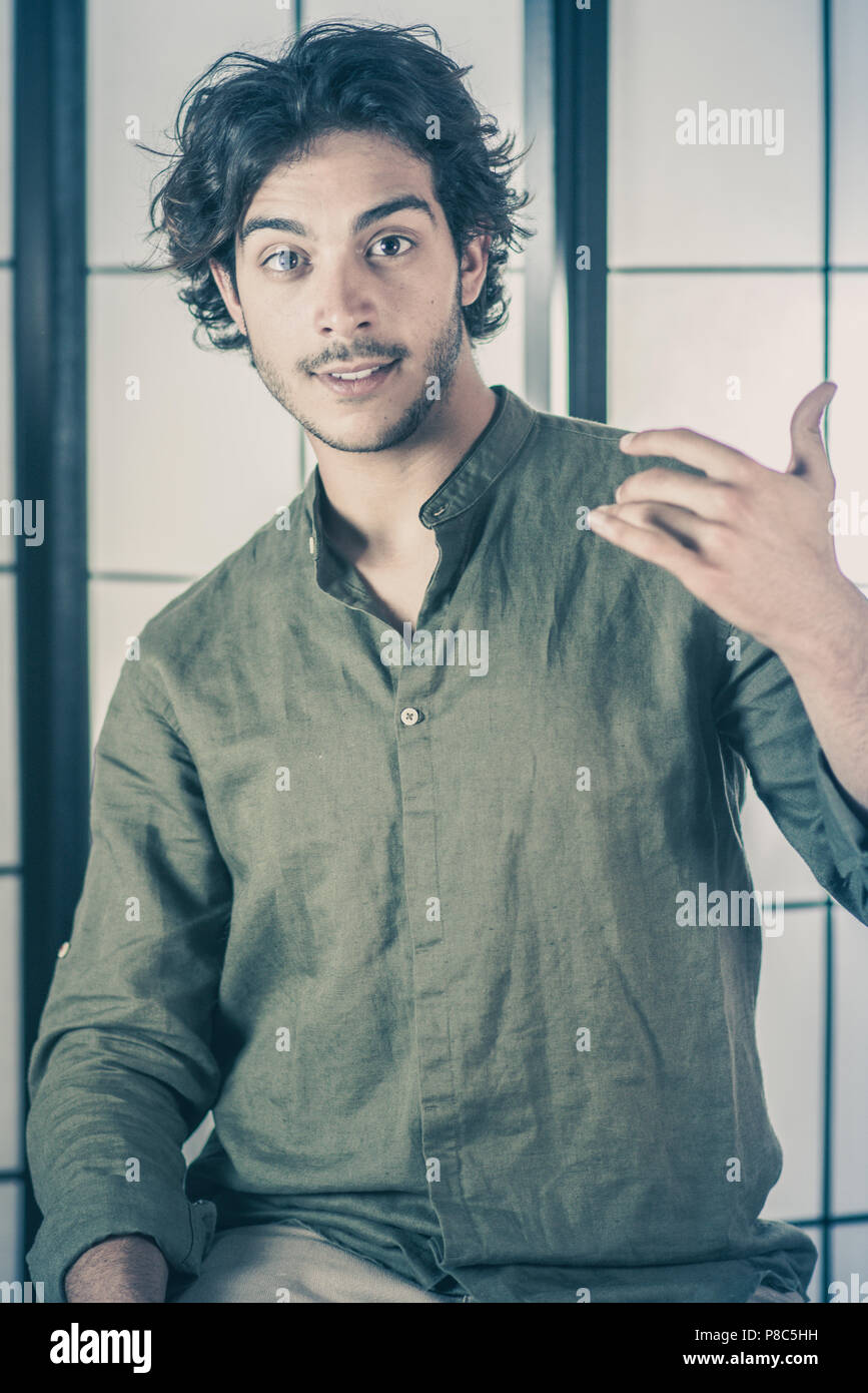 Portrait of Young Man With Raised Hands at Chest Stock Photo - Alamy