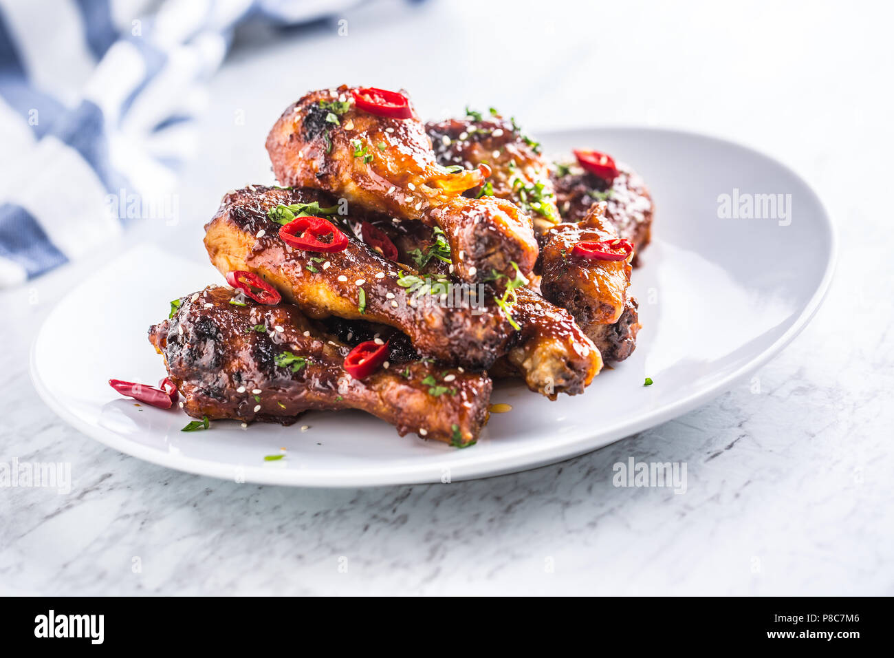 Grilled roasted and barbecue chicken legs on white plate Stock Photo ...