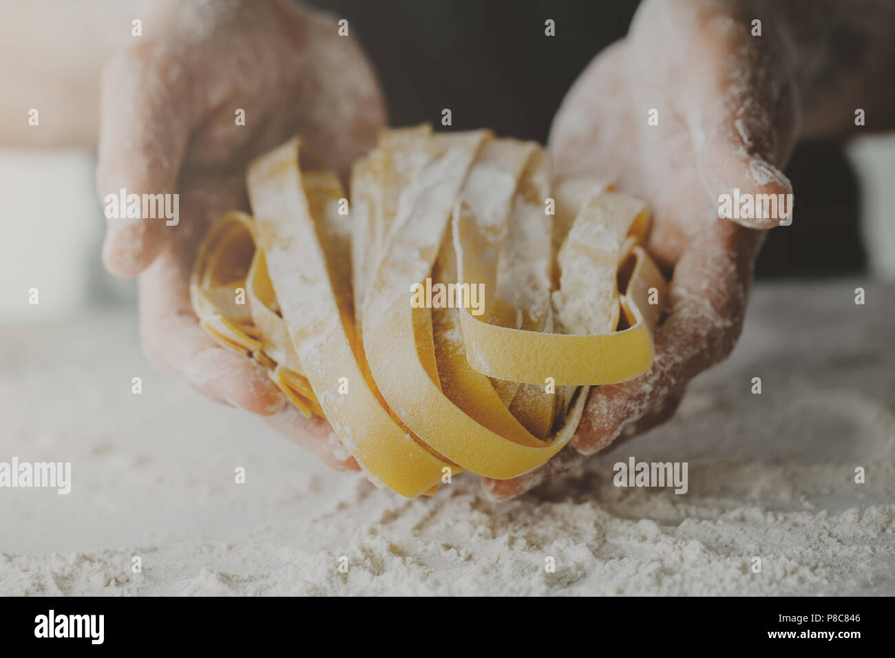 Closeup of process of cooking homemade pasta. Chef make fresh italian ...