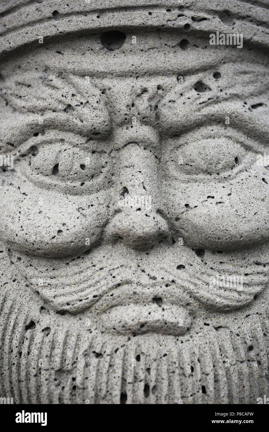 Angry face of a stone sculpture in South Korea Stock Photo - Alamy