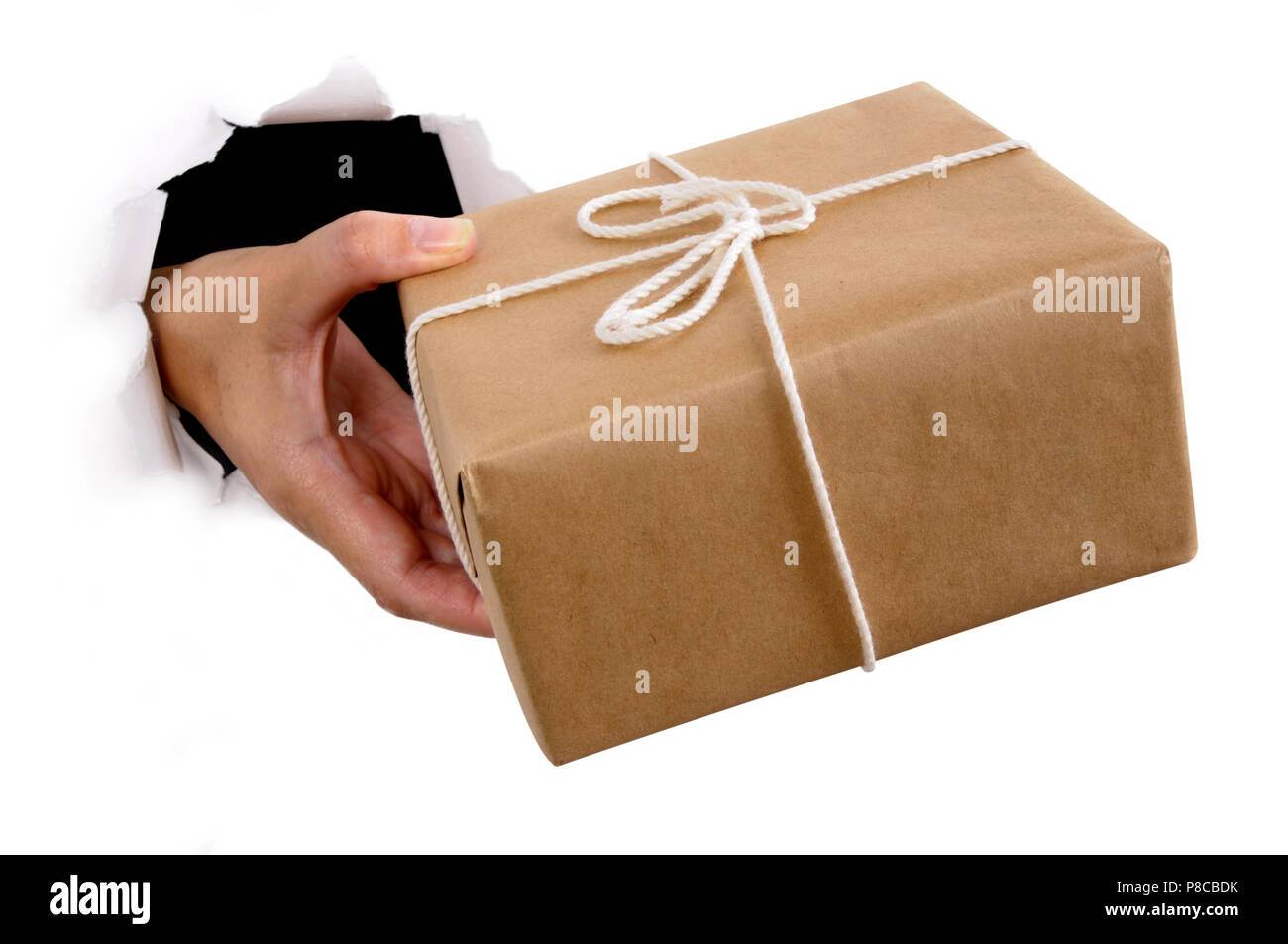 Man hand delivering or giving parcel through torn white paper ...