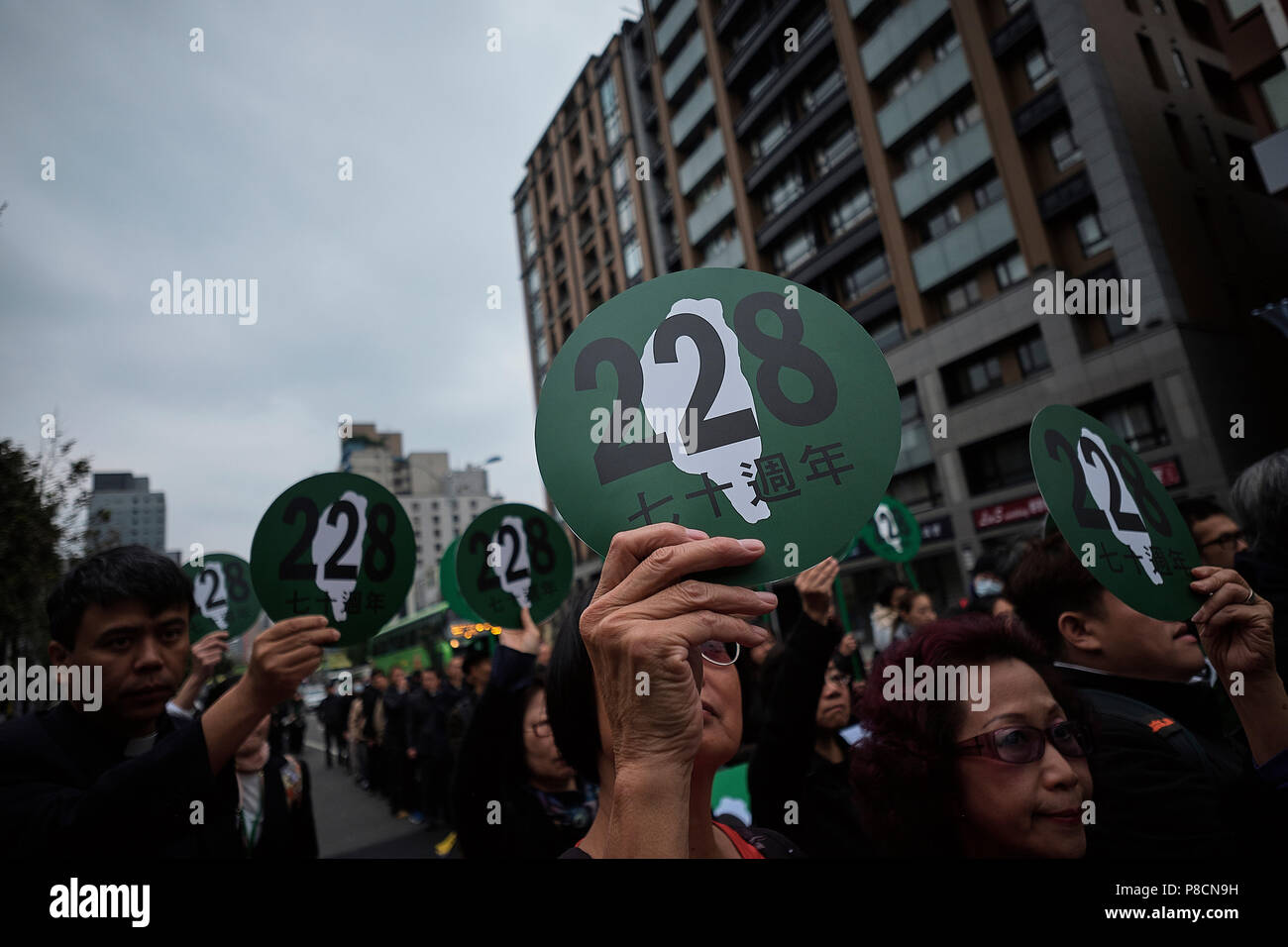 Peoples hold a 228 placard during a demonstration in Taipei. 30 years ...