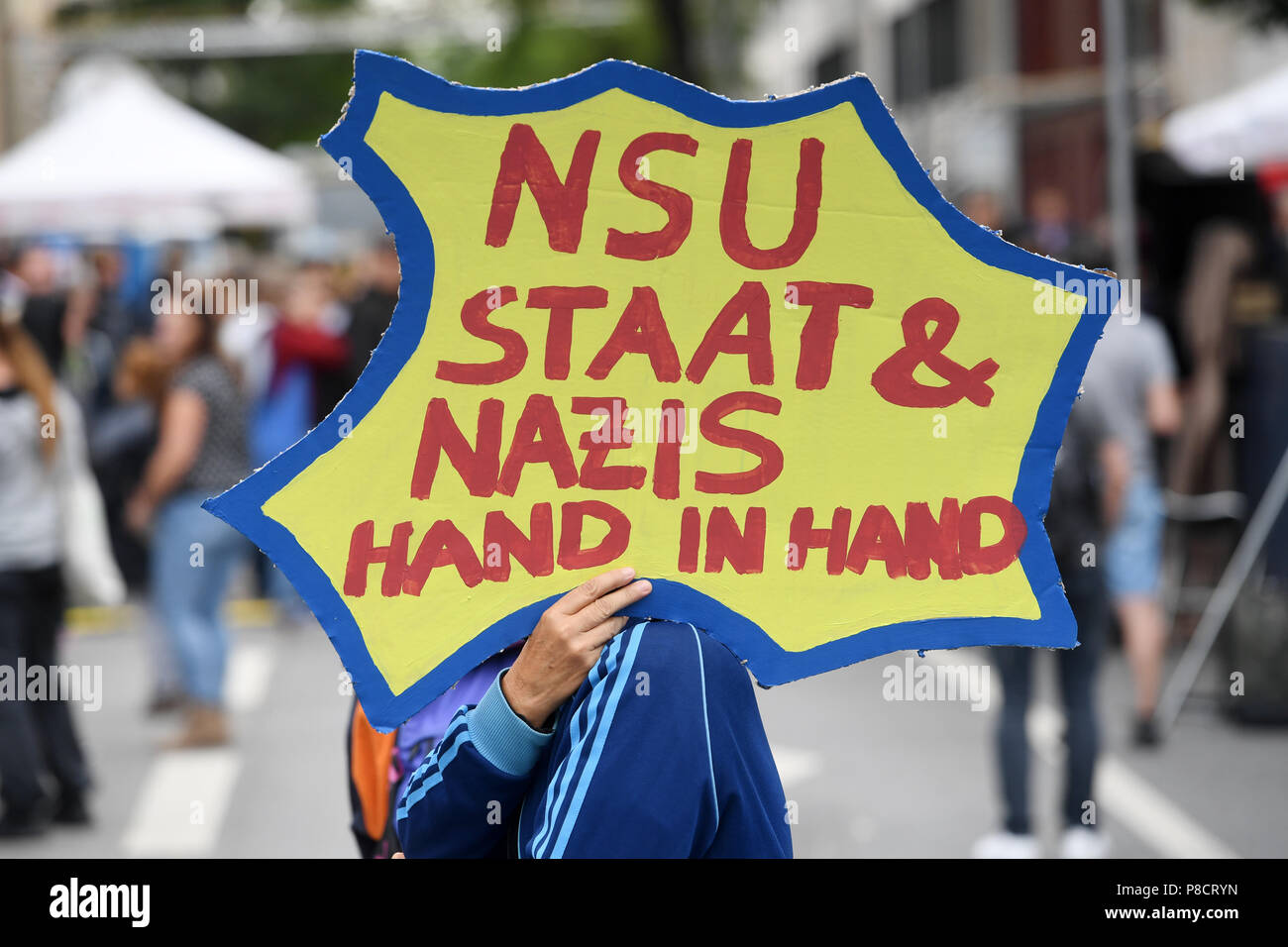 Germany, Munich. 11th July, 2018. Demonstrators hold a sign saying "NSU ...