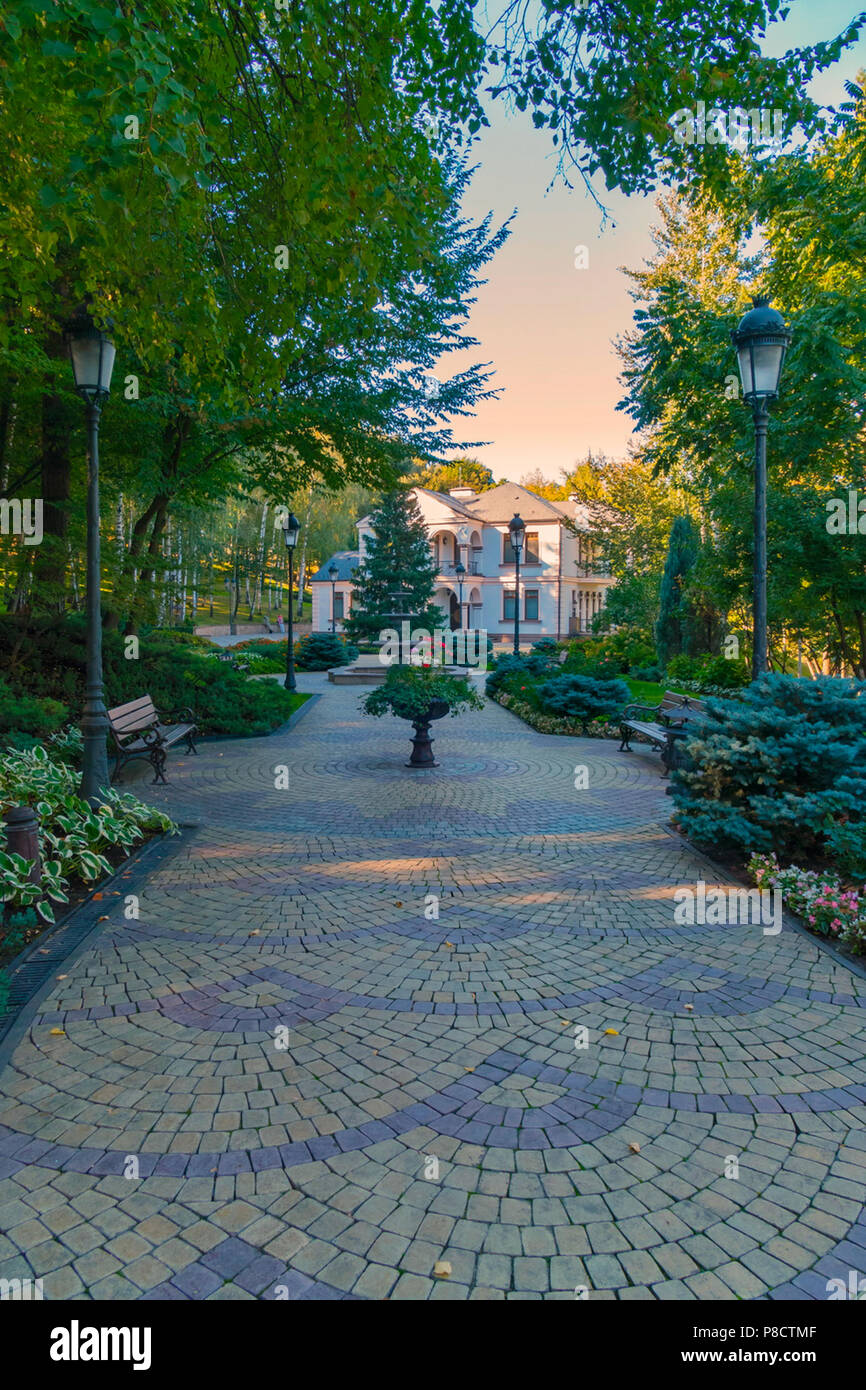 beautiful alley lined with stone leading to the house in the distance ...