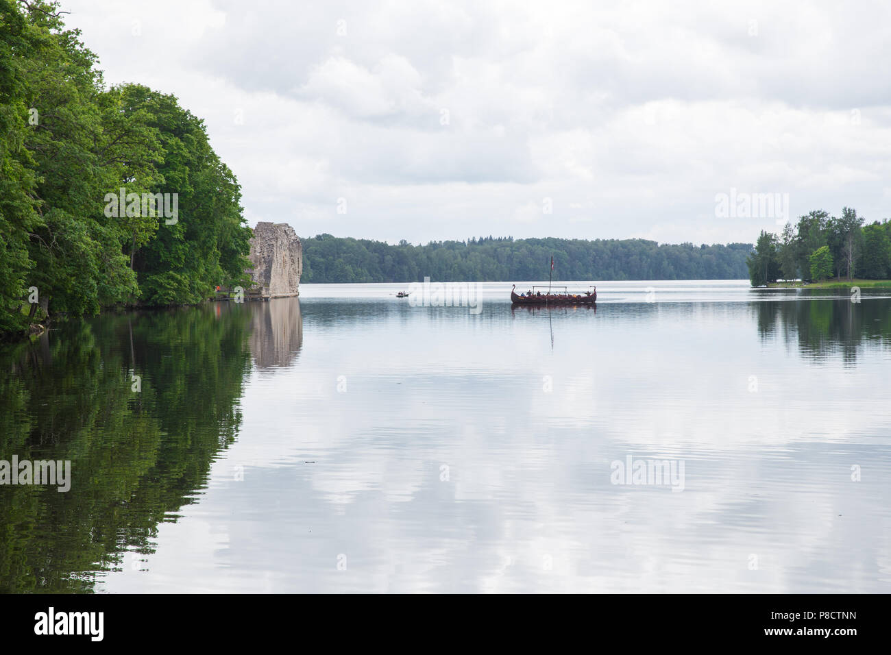 City Koknese, Latvia. Old river and green trees. Ruins and reflection ...